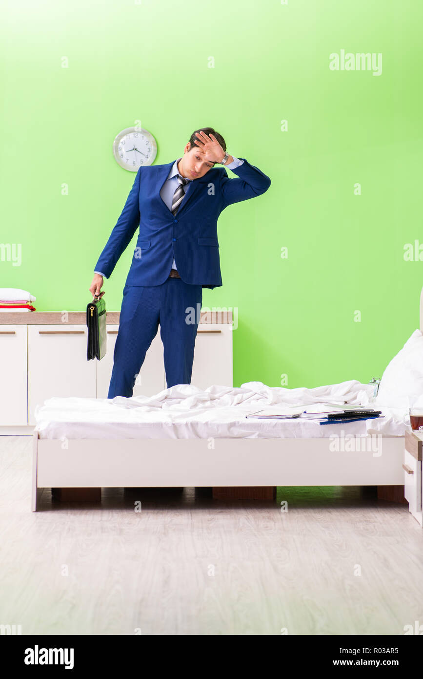 Businessman working overtime in hotel room Stock Photo - Alamy