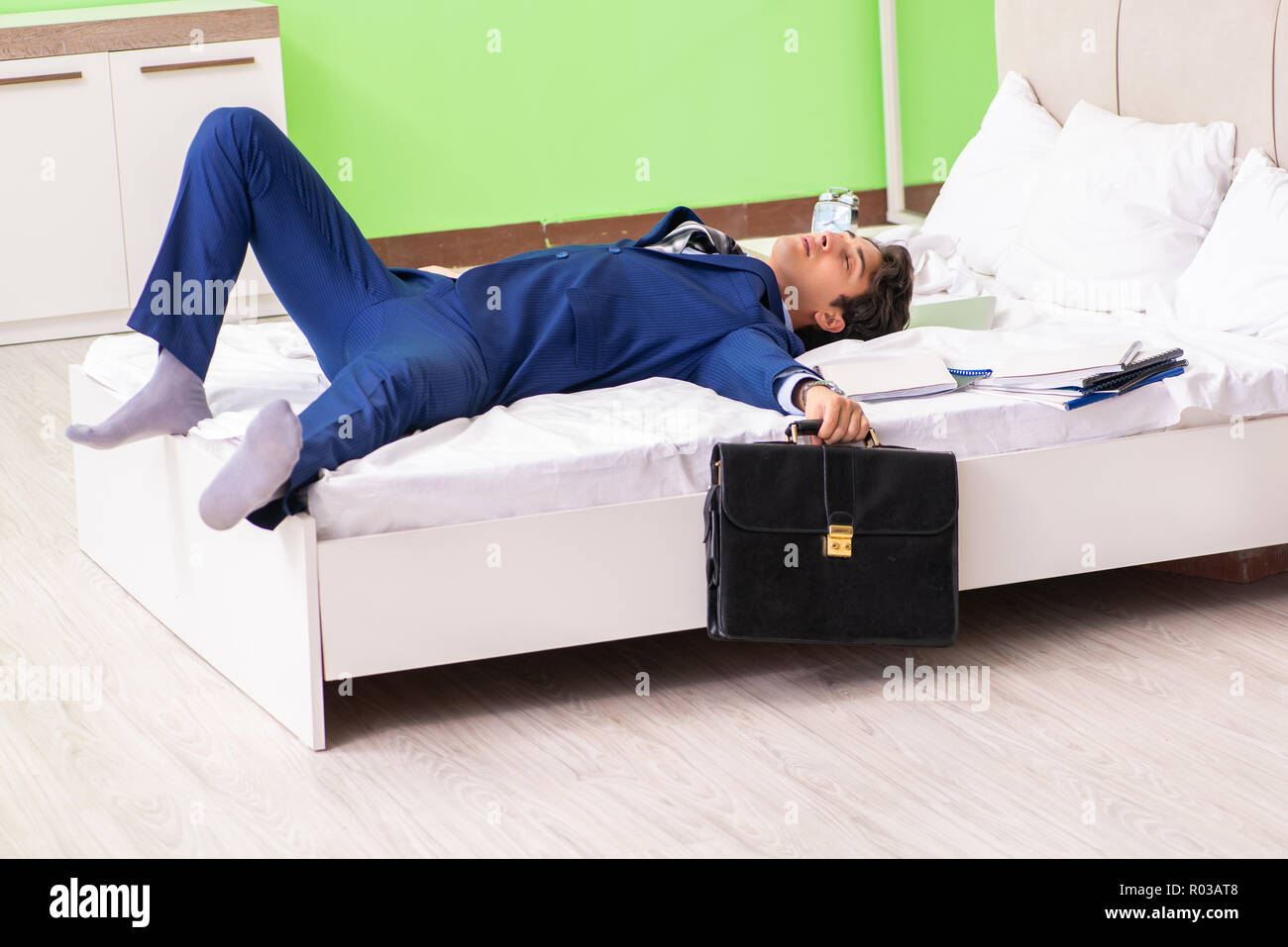 Businessman working overtime in hotel room Stock Photo - Alamy