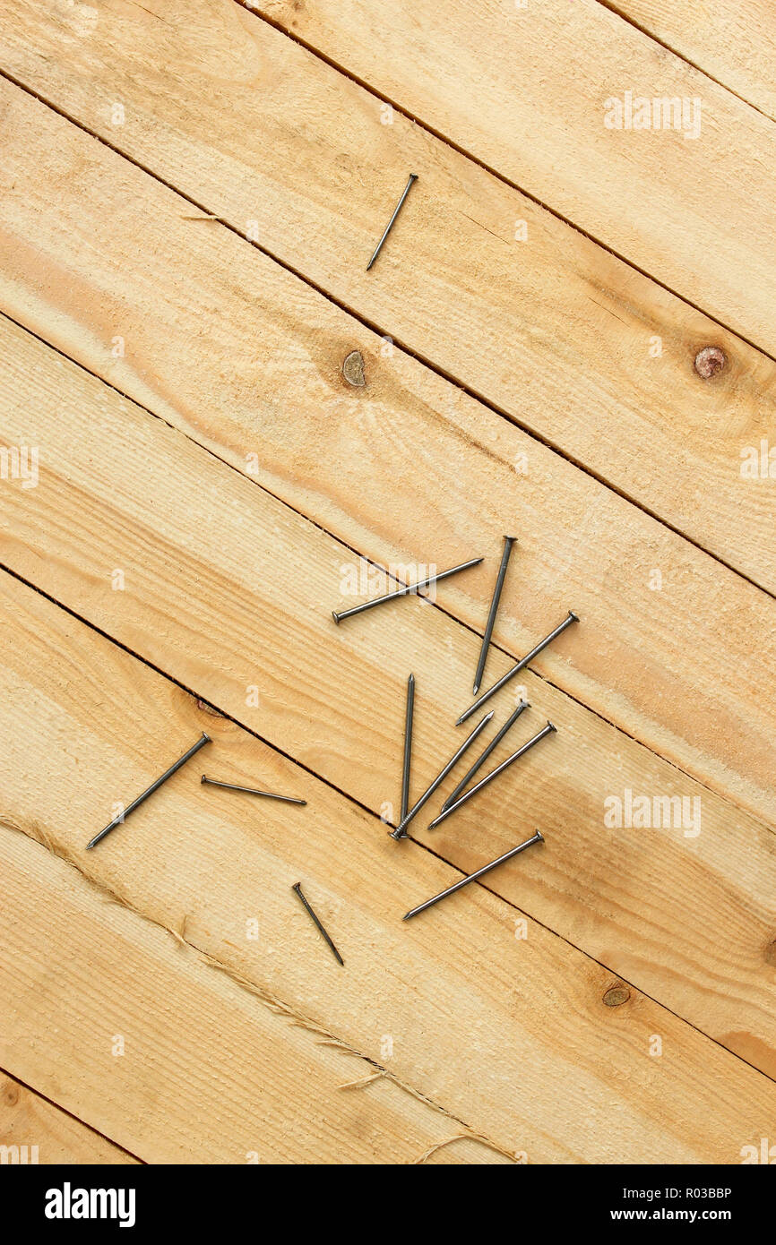 Nails are scattered on a wooden shield with a new parallel boards Stock ...