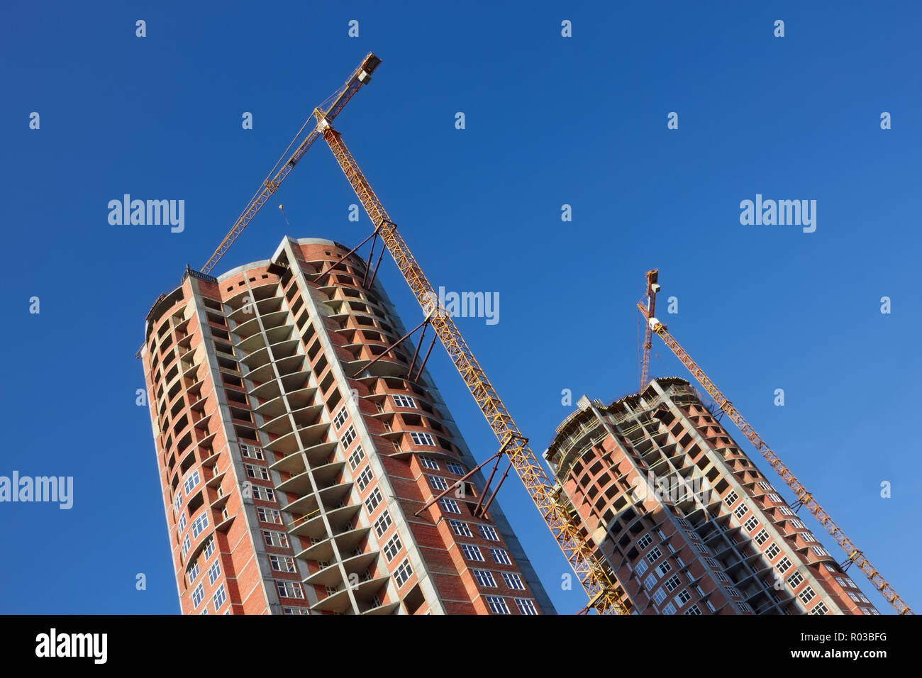 Building cranes on the construction of dwelling two parallel ...