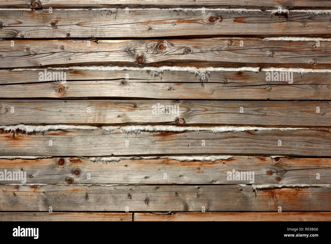 Horizontal parallel old wooden logs with heat insulation material ...