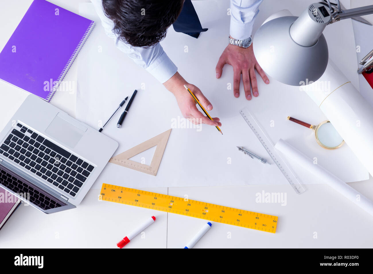 Engineer working on new project drawings Stock Photo - Alamy