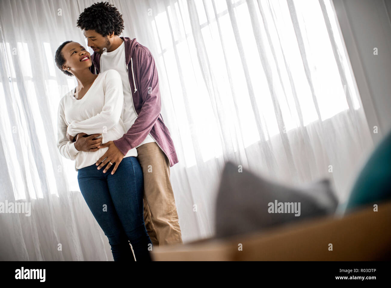 Happy young man embracing his beautiful partner Stock Photo - Alamy