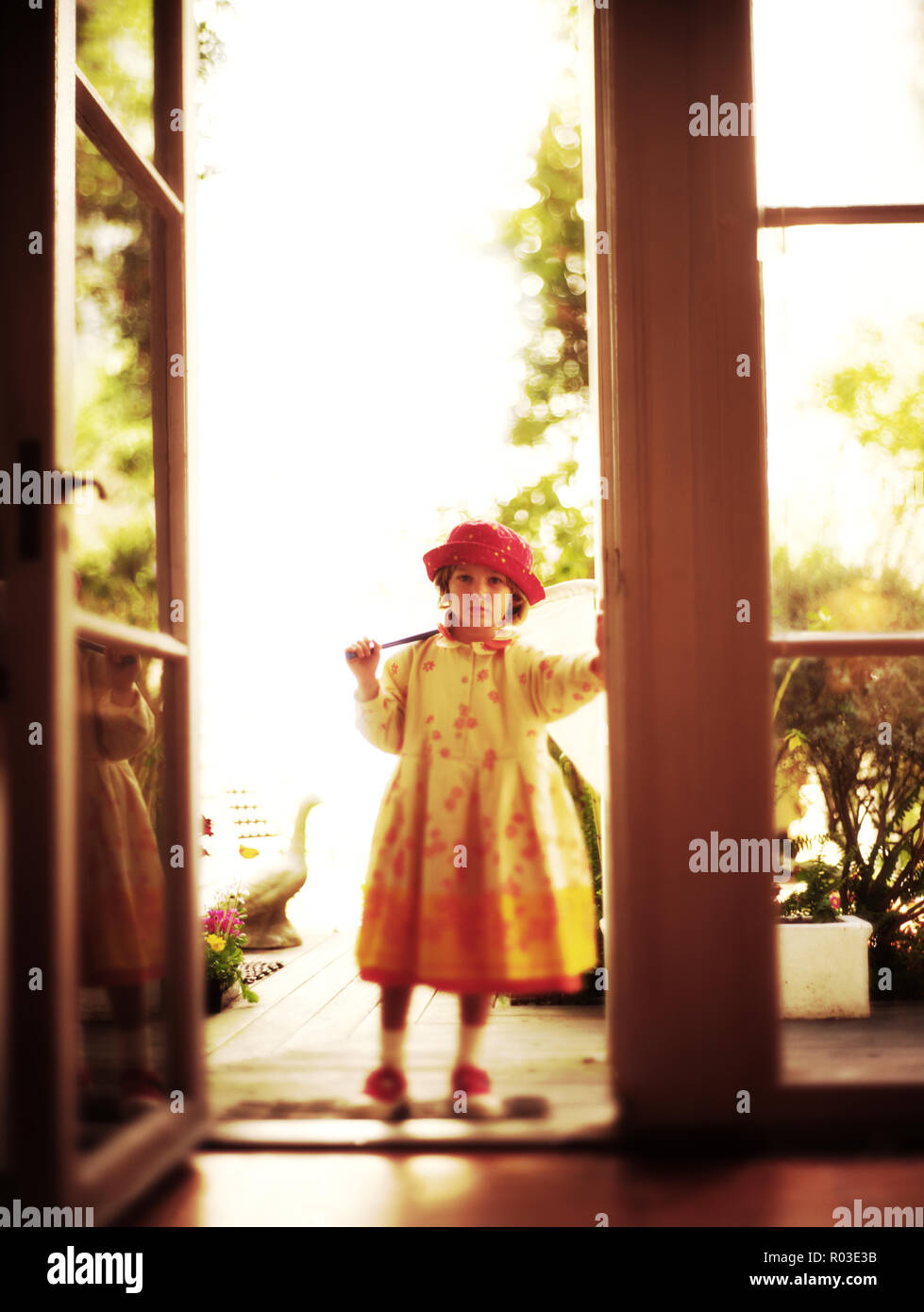 Front view a small girl standing at a doorstep Stock Photo - Alamy