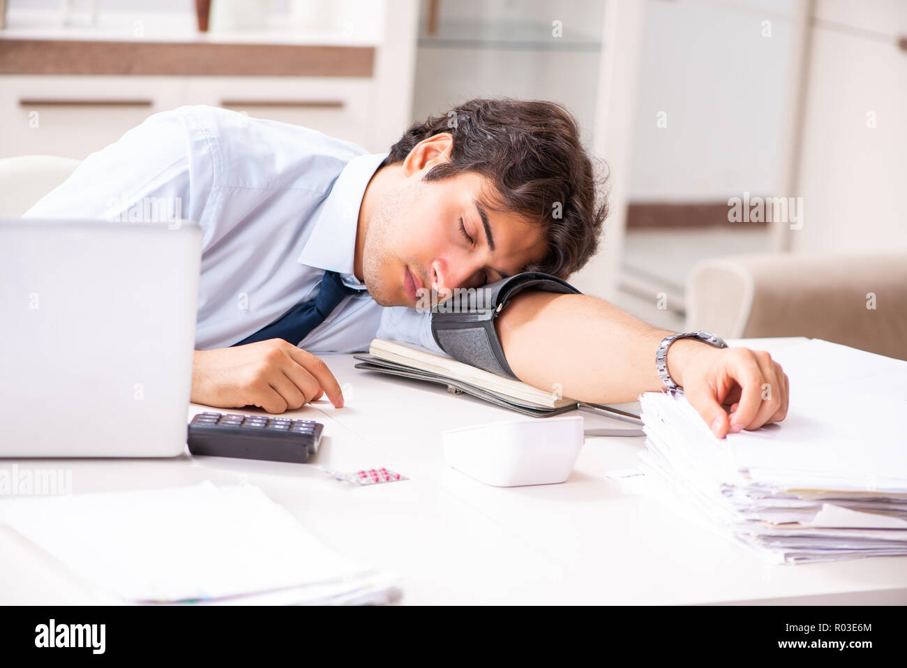 Man under stress measuring his blood pressure Stock Photo - Alamy