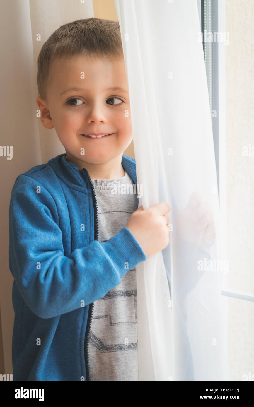 Child hiding behind curtain hi-res stock photography and images - Alamy