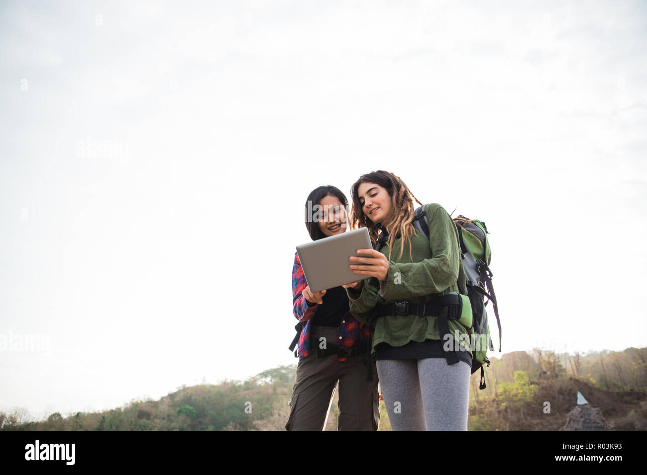 lost hiker looking at the way through map during hiking in wilderness ...