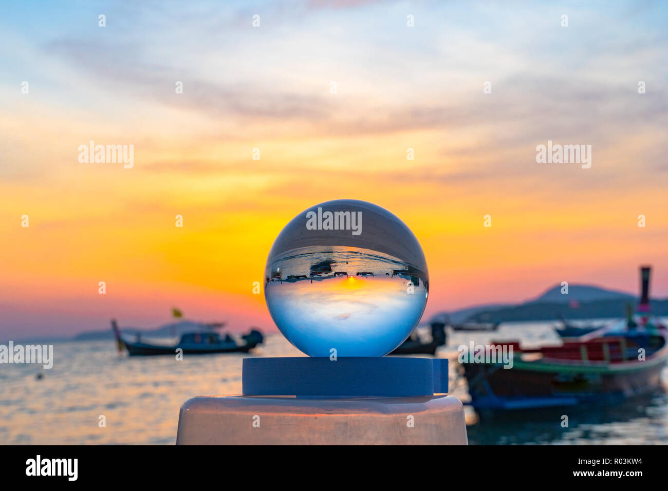 crystal glass ball sphere reveals sunrise seascape with spherical ...