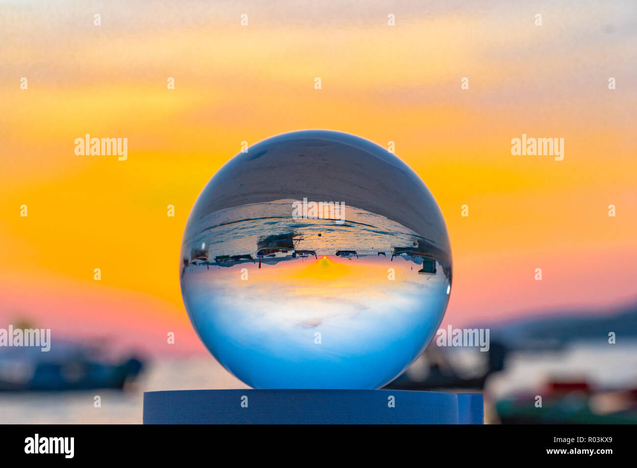 crystal glass ball sphere reveals sunrise seascape with spherical ...