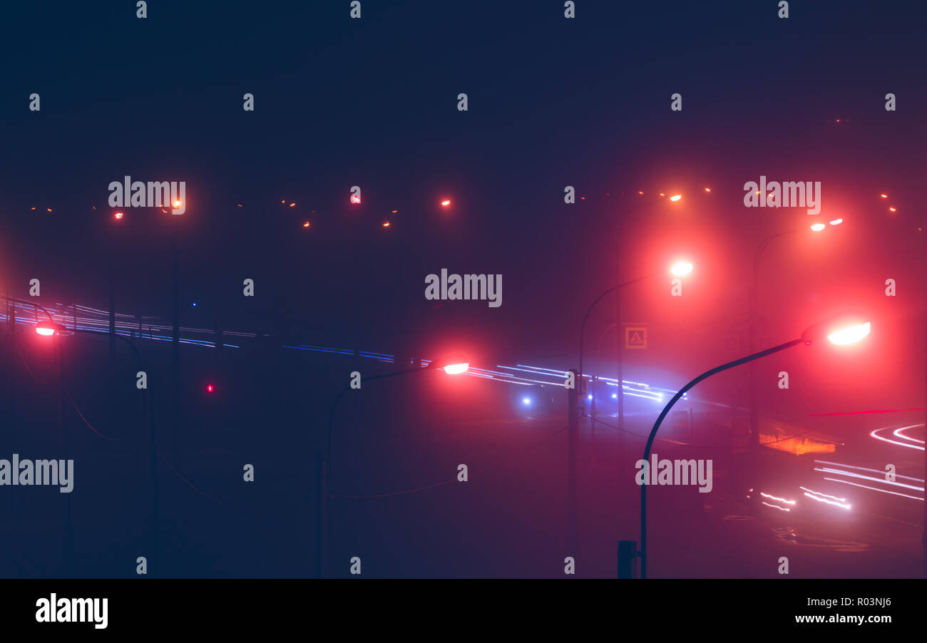 Neon lights of night city and motion traffic in fog. Retro colored ...