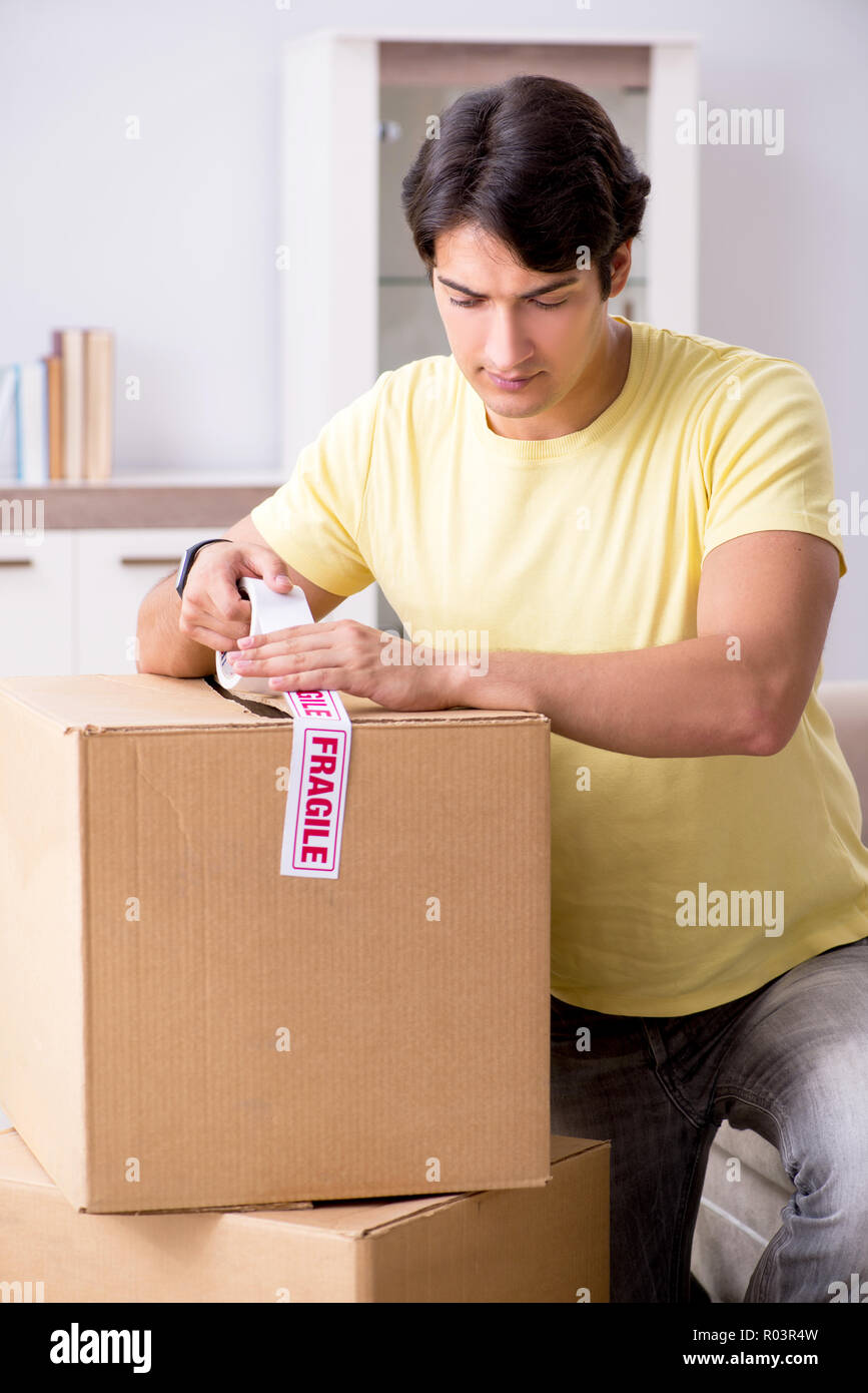 Man moving house and relocating with fragile items Stock Photo - Alamy