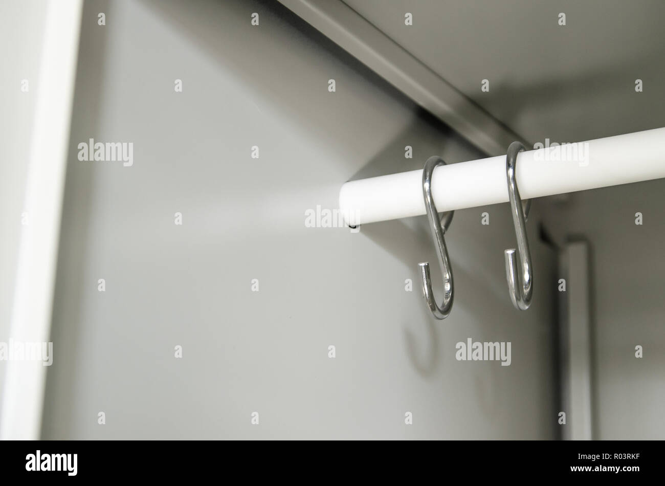 white metal locker with stainless steel hangers Stock Photo - Alamy