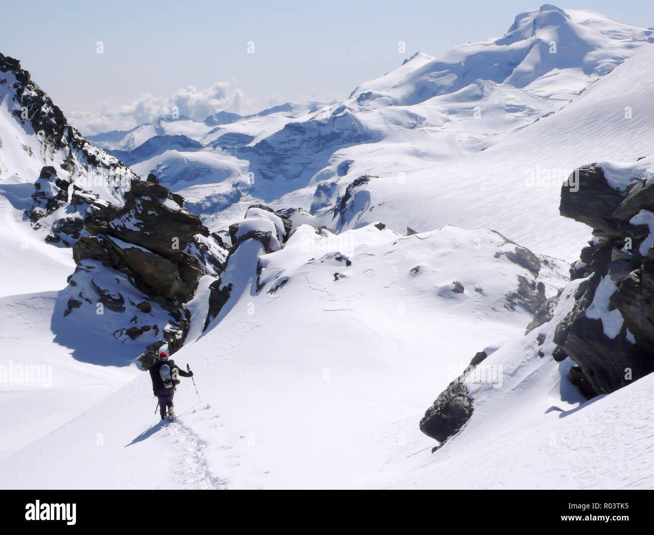 mountain climber carrying a lot of climbing equipment in the Mischabel ...