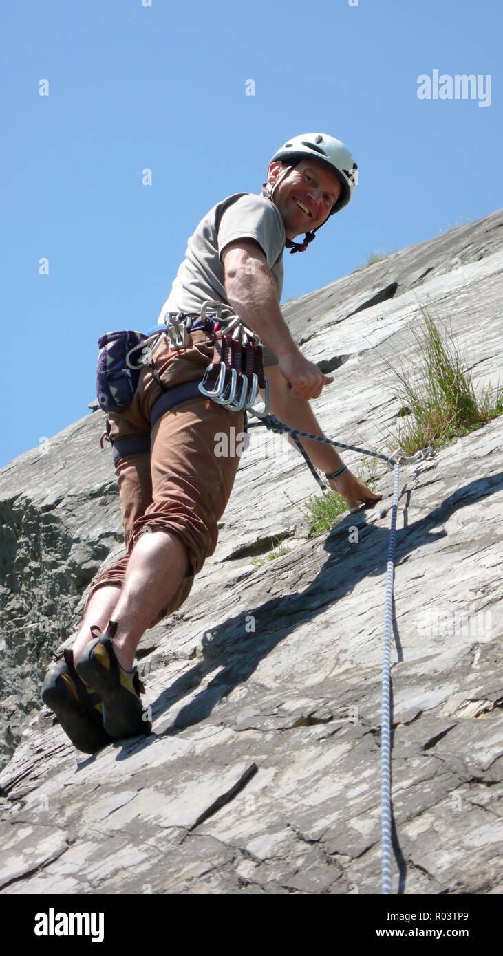 mountain guide rock climber on a slab limestone climbing route in the ...