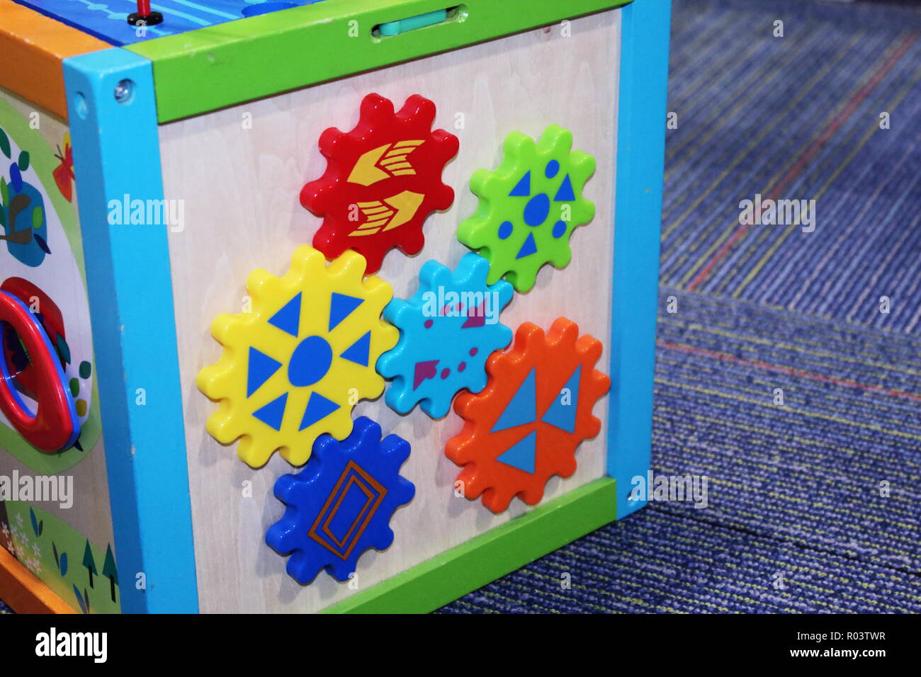 Child's box toy with gears in many colors Stock Photo - Alamy