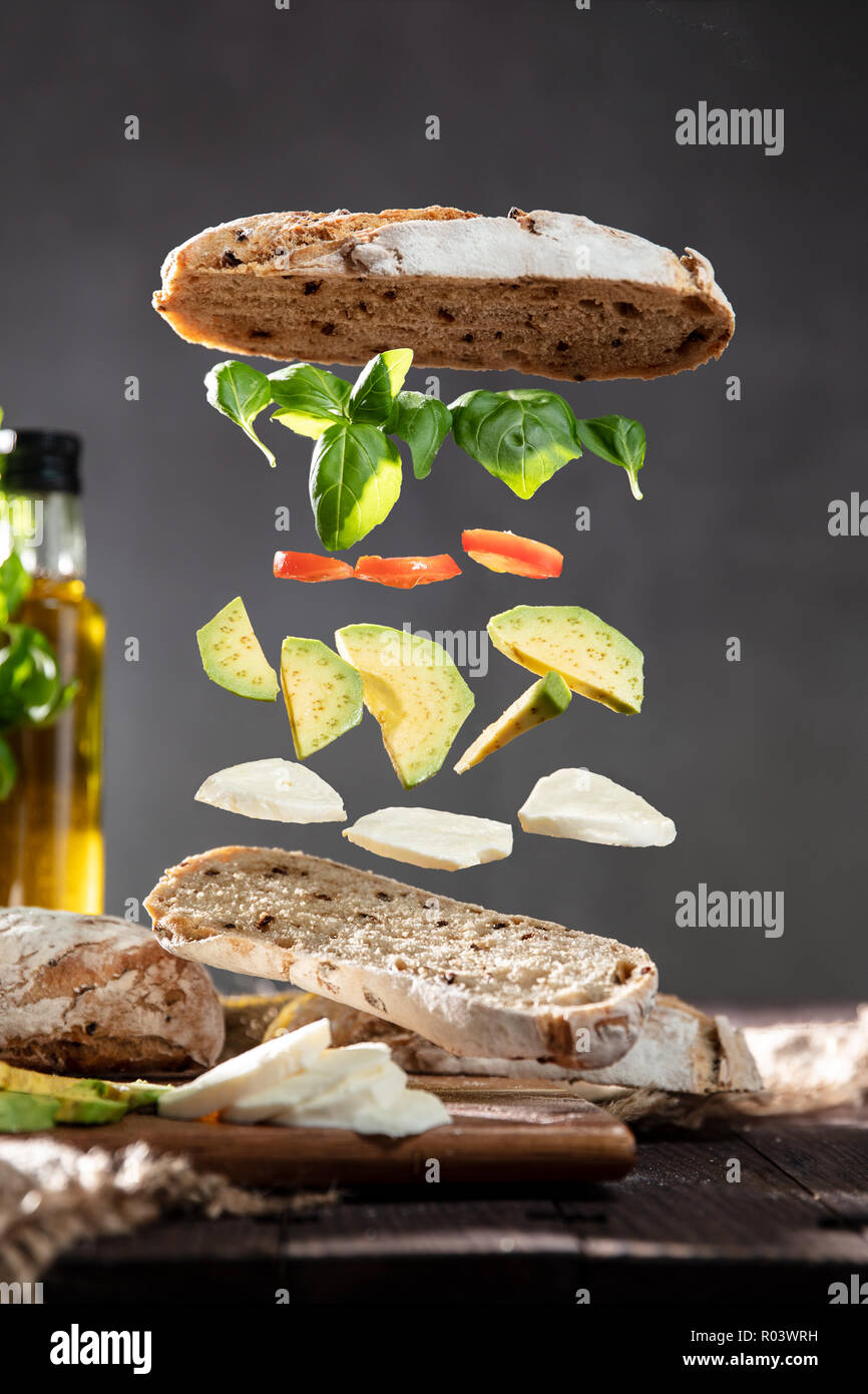 Isolated ingredients for a sandwich floating in air in layers with a ...