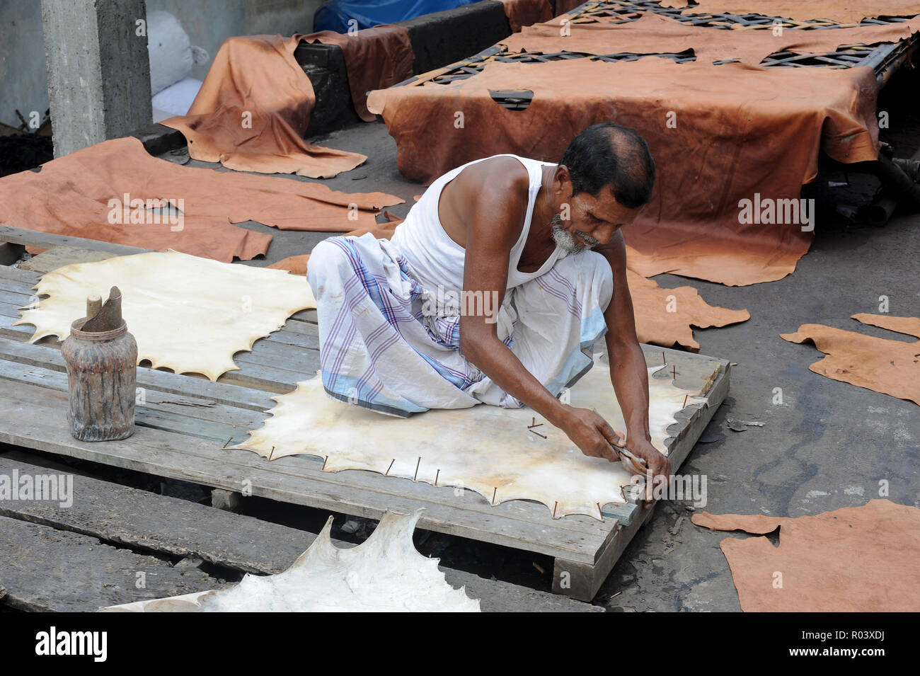 Dhaka, Bangladesh - April 04, 2016: Bangladeshi tannery workers process ...