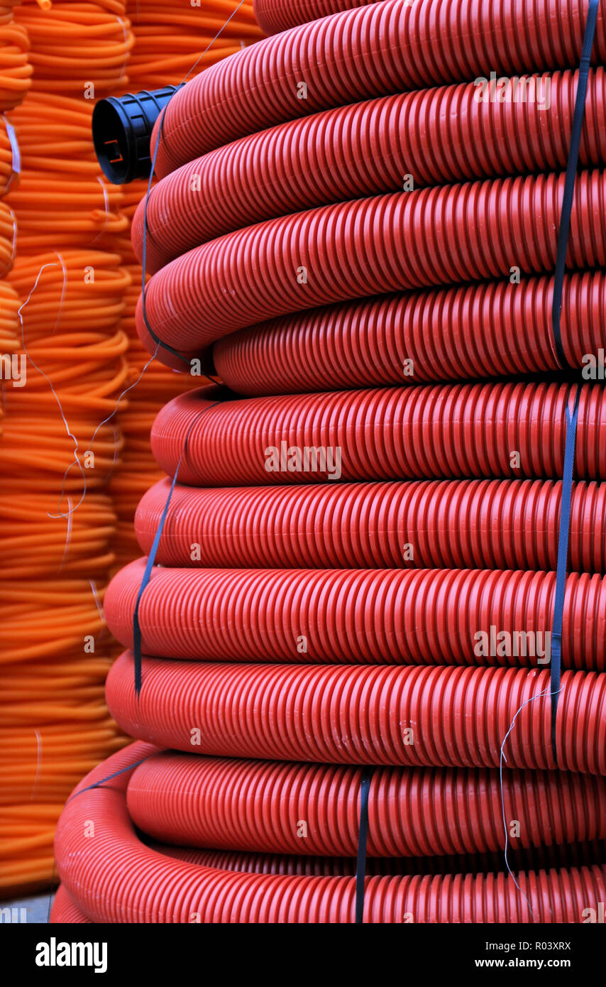 Big pile of red plastic cables in coils Stock Photo - Alamy