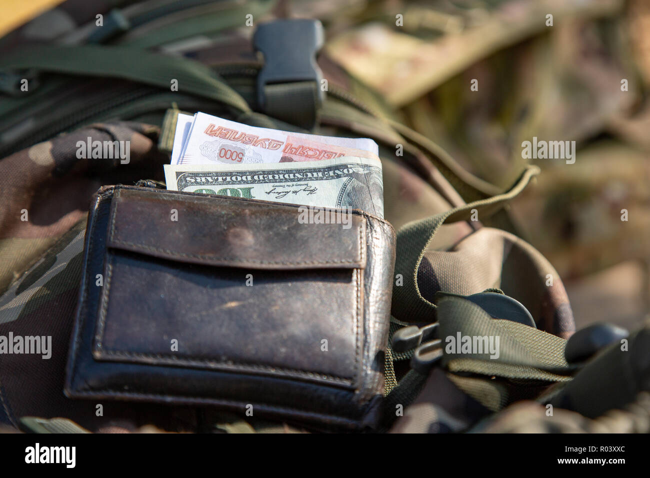 Corruption concept. Money of different countries in a wallet placed on ...