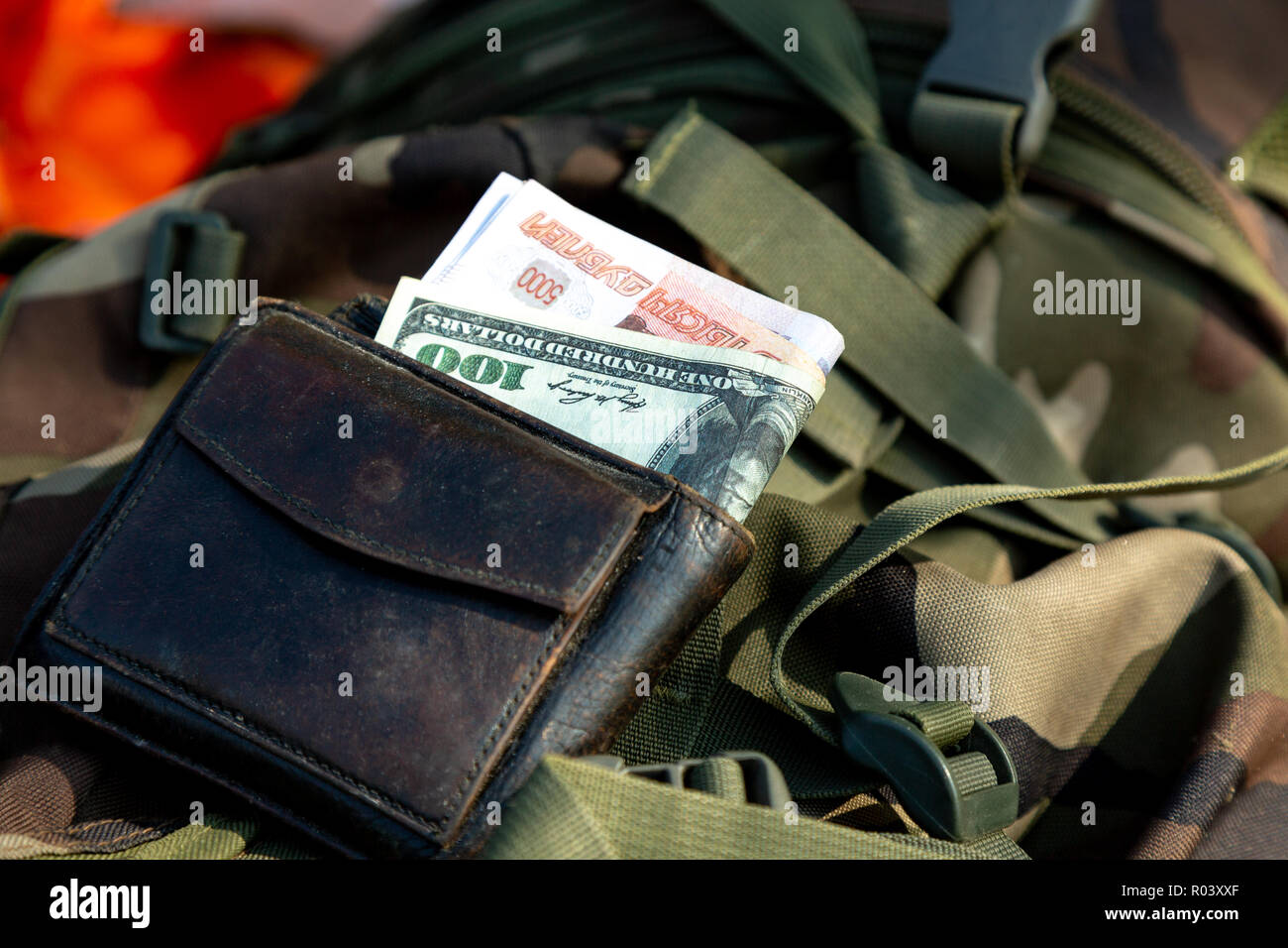 Corruption concept. Money of different countries in a wallet placed on ...