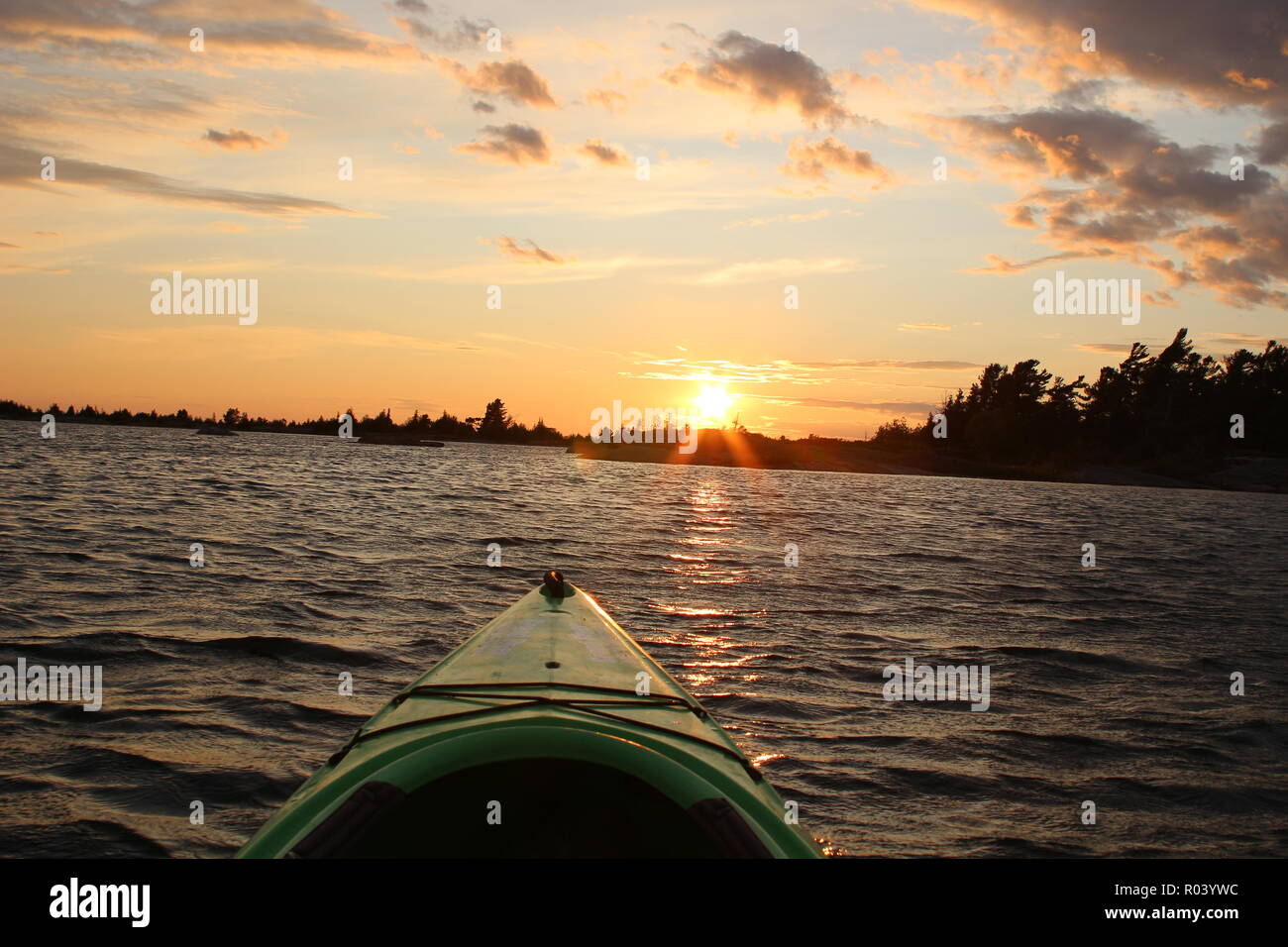 Image of empty red canoe floating, Georgian Bay sunset Stock Photo - Alamy