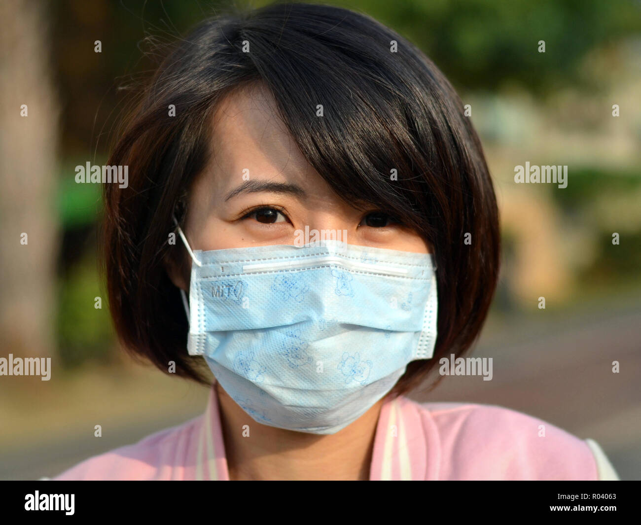 Young Taiwanese woman with beautiful oriental eyes wears a light-blue ...