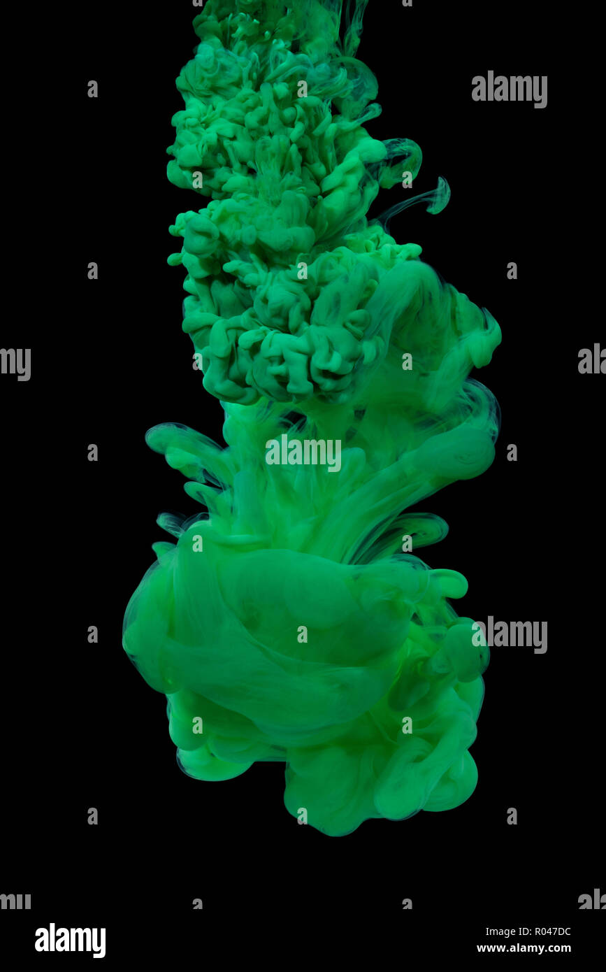 Explosion of green acrylic paint in water on black background Stock ...