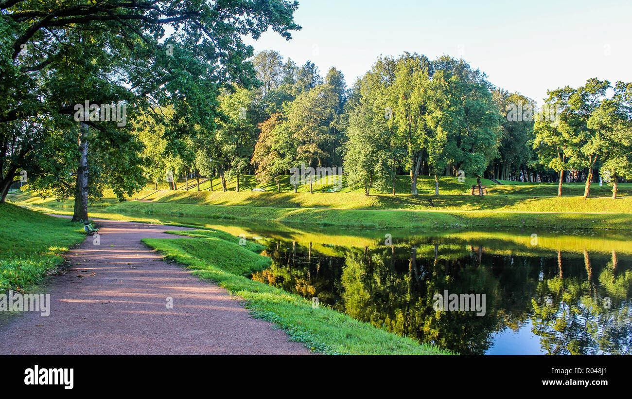 Summer park path. Green trees, stone paths. Walk in the fresh air ...