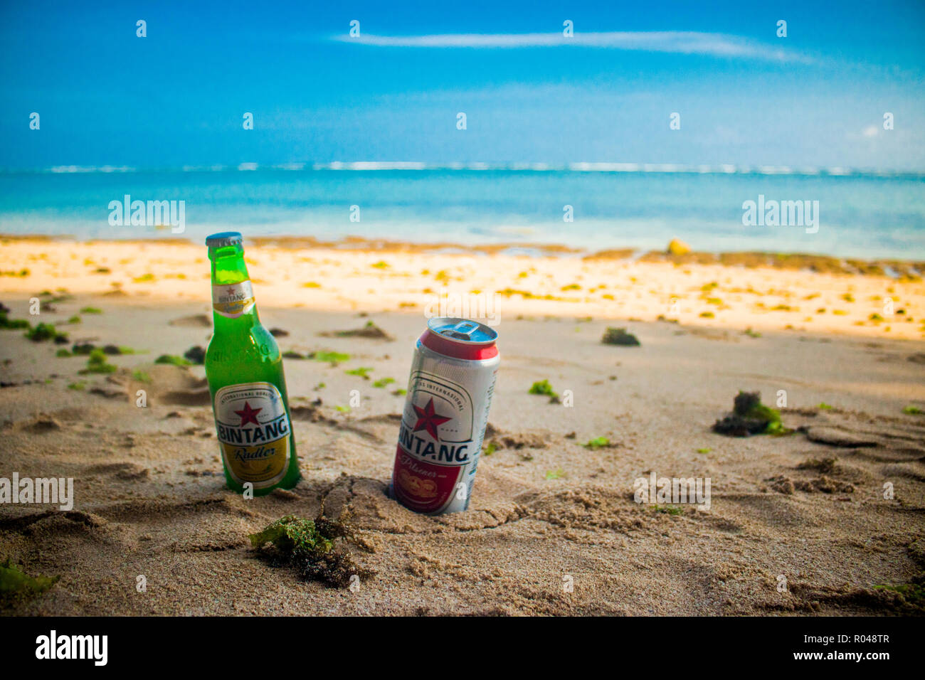 summer holiday beach theme beer with feet on beach Stock Photo - Alamy