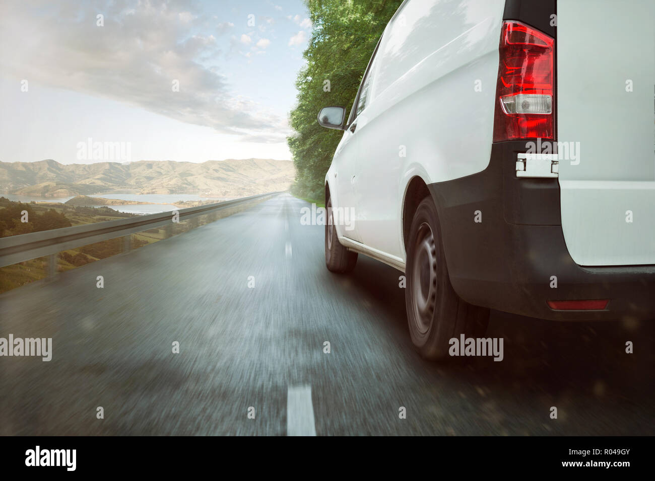 Delivery van driving through nature Stock Photo - Alamy