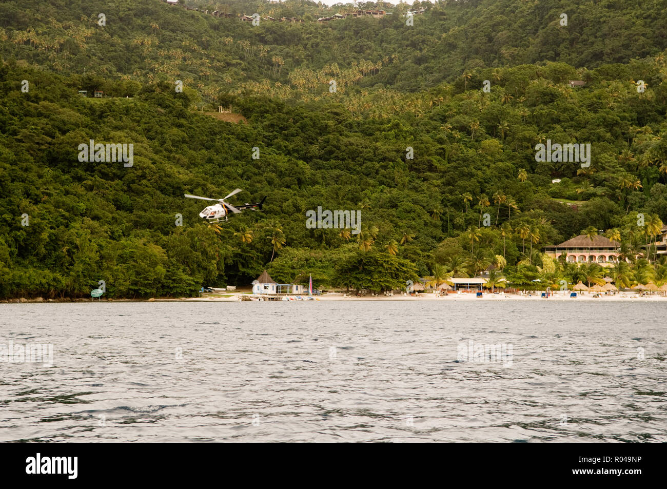 Helicopter over sea by resort Stock Photo - Alamy