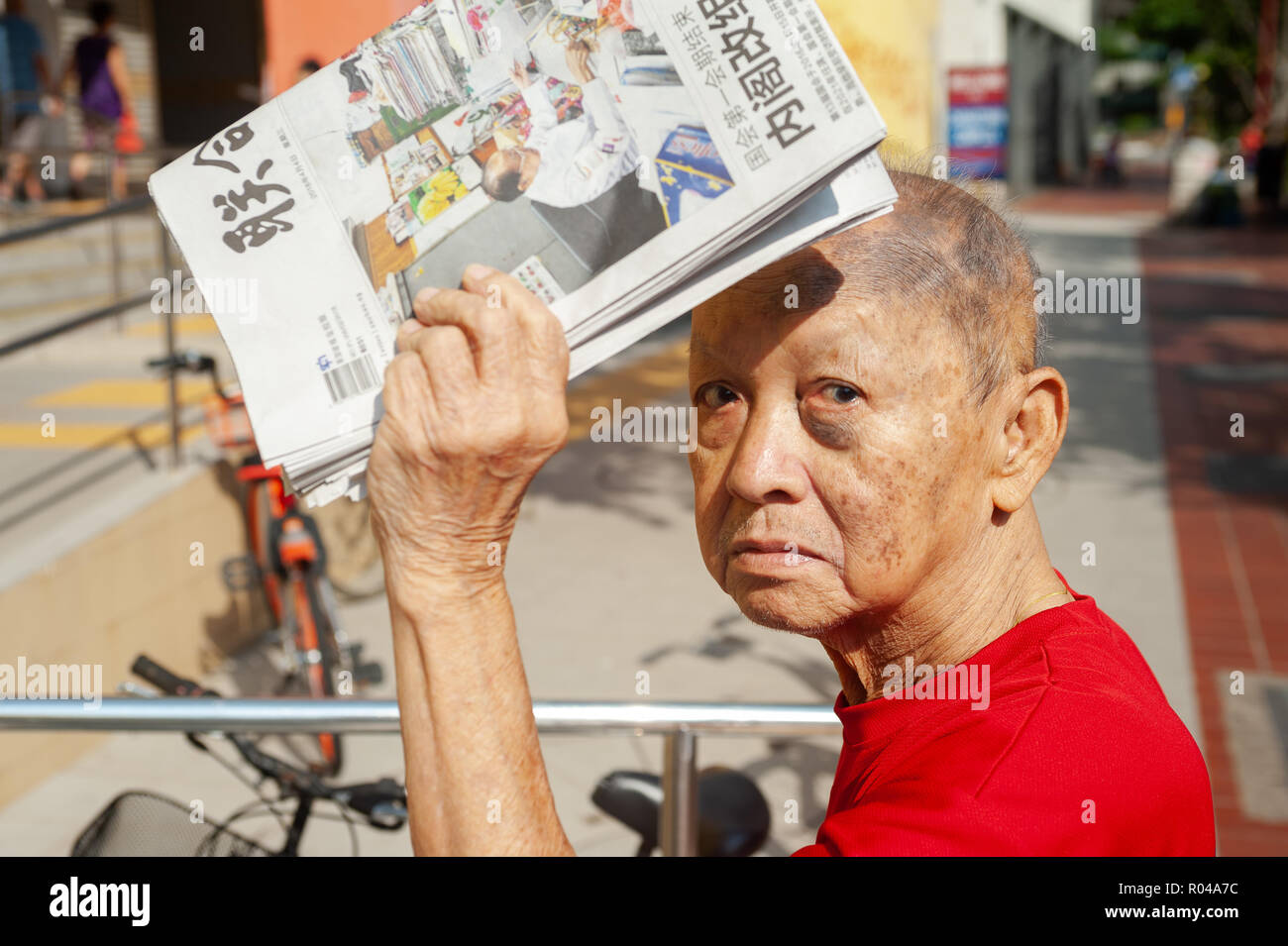 Republic of Singapore, man with a newspaper in Chinatown Stock Photo ...