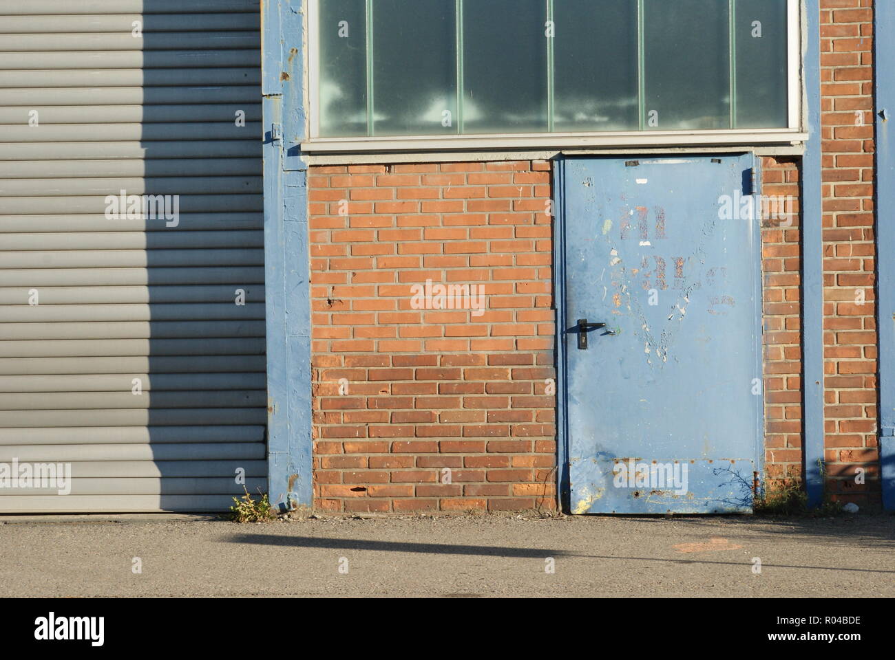 old factory building in Bremen Ueberseestadt with a blue door and red ...