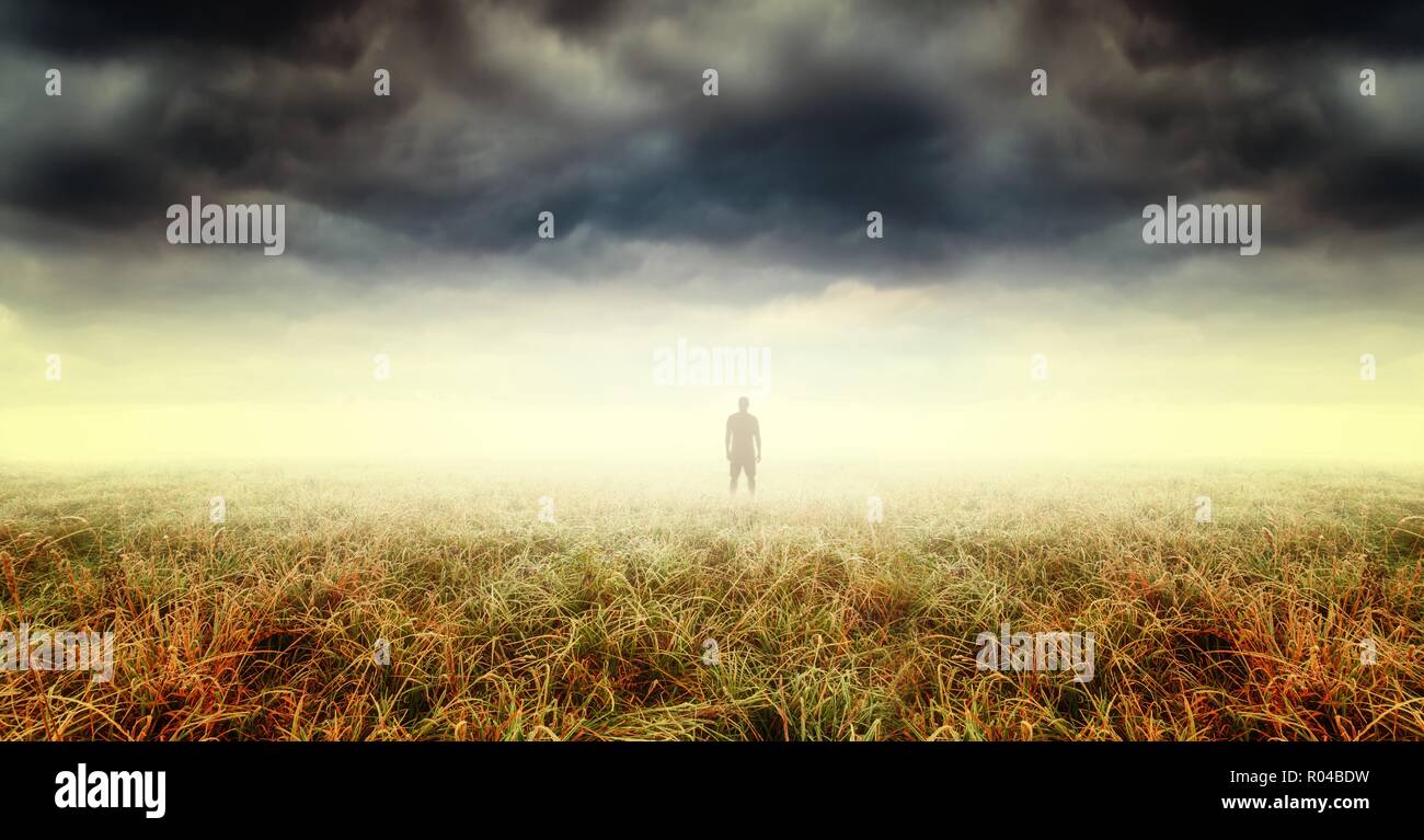 Silhouette of strange man standing in distant fog. Spooky, surreal ...