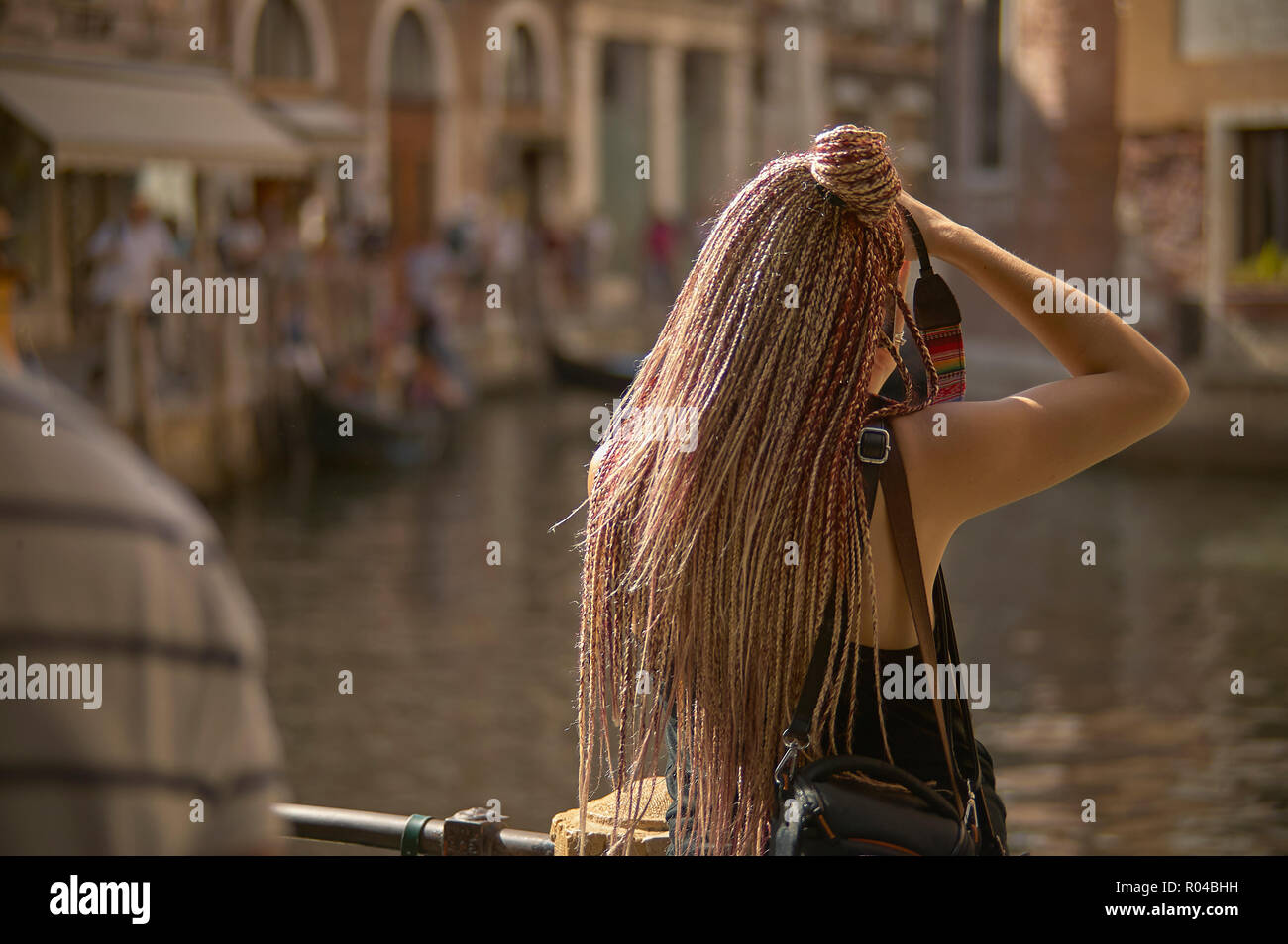Shoulder girl photographing a glimpse of venice Stock Photo - Alamy