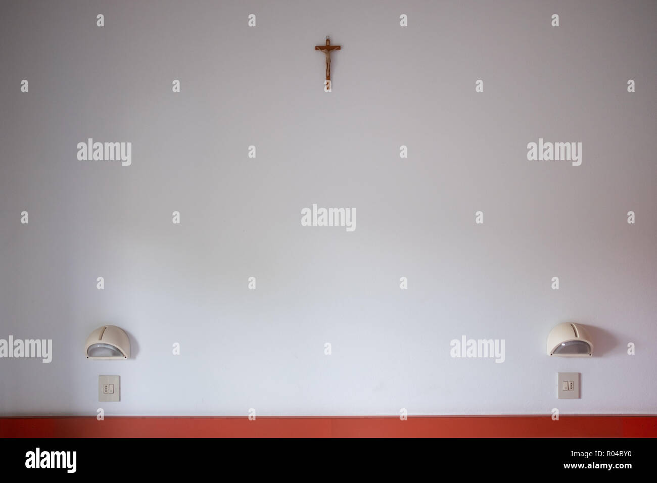 Crucifix on a white wall in a hotel room Stock Photo - Alamy