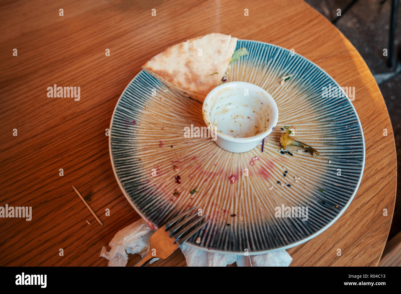 Table after eating with empty plate and remains on it, shot with ...