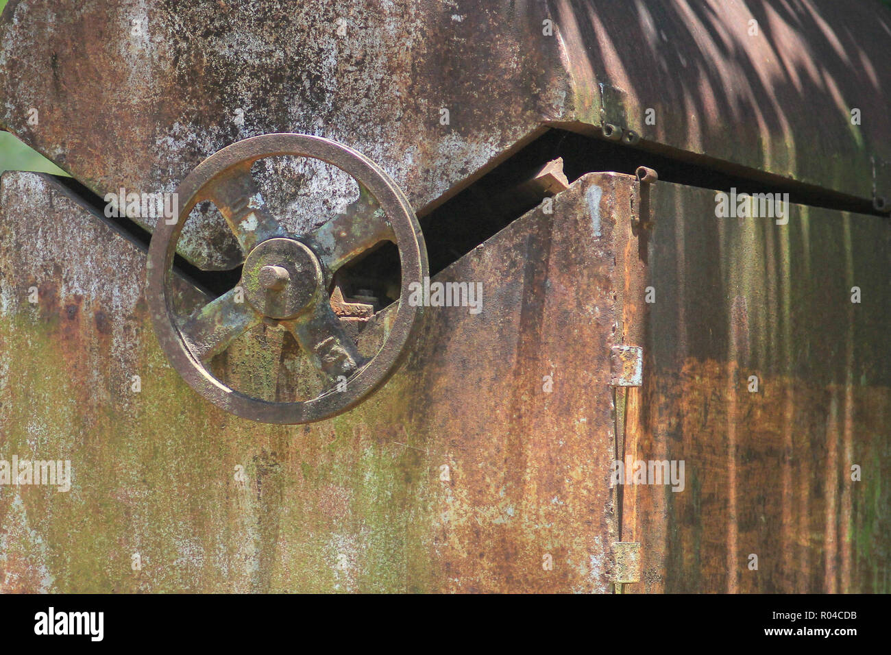 old abandoned rusty machine with pulley wheel Stock Photo - Alamy