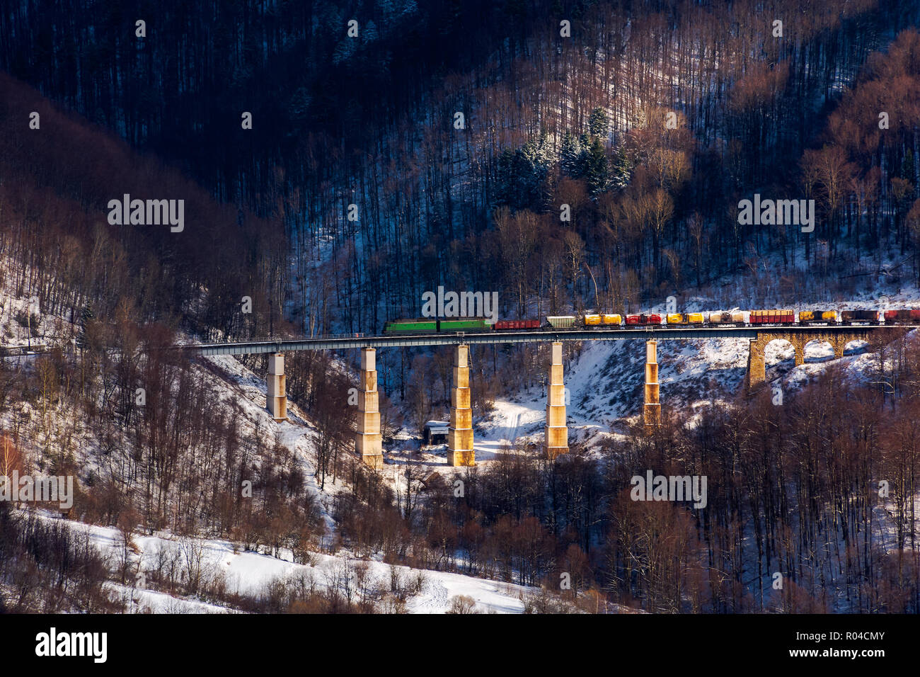 winter rail road transportation in mountains. freight train with ...
