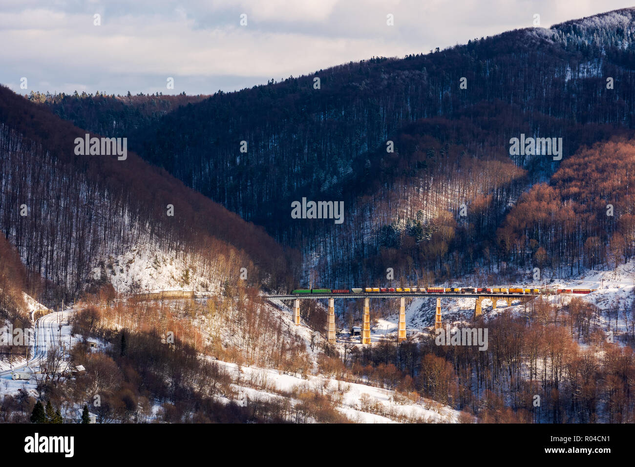 winter rail road transportation in mountains. freight train with ...