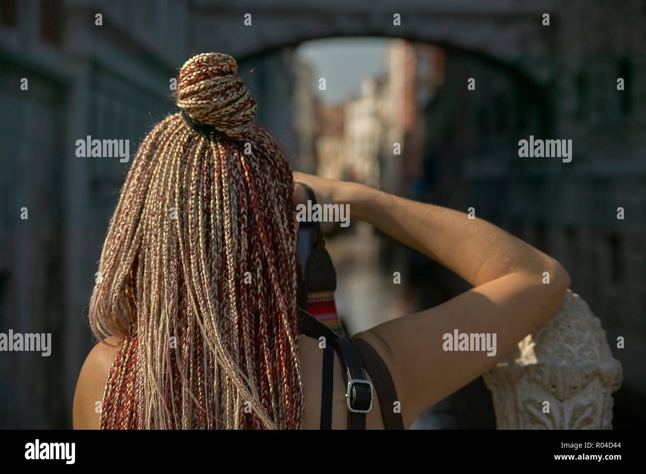 Shoulder girl photographing a glimpse of venice Stock Photo - Alamy