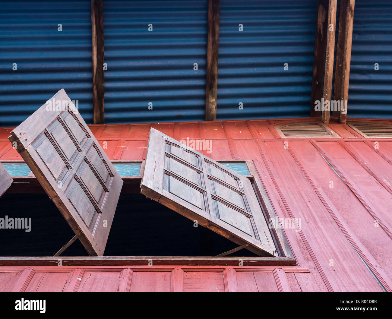 Wooden window is opened on the second floor of the countryside house ...