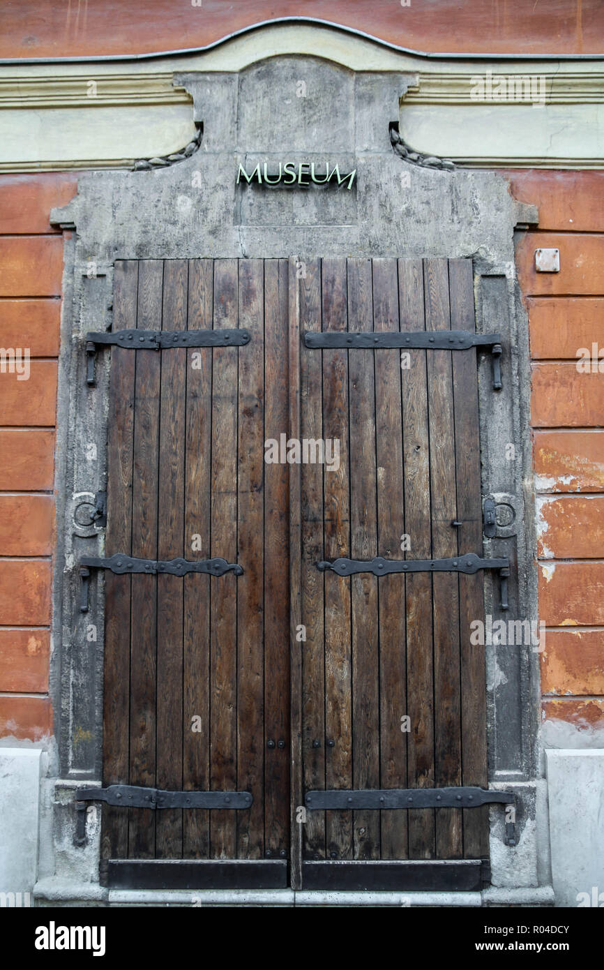 Old brown wood double closed Museum door with reddish brown brick walls ...