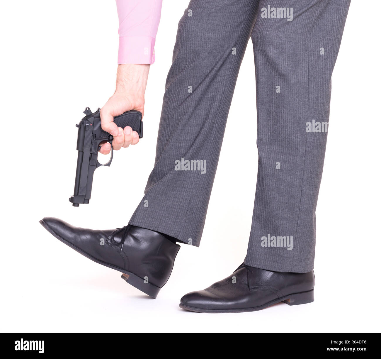 Concept - Businessman shooting himself in the foot with a handgun Stock ...