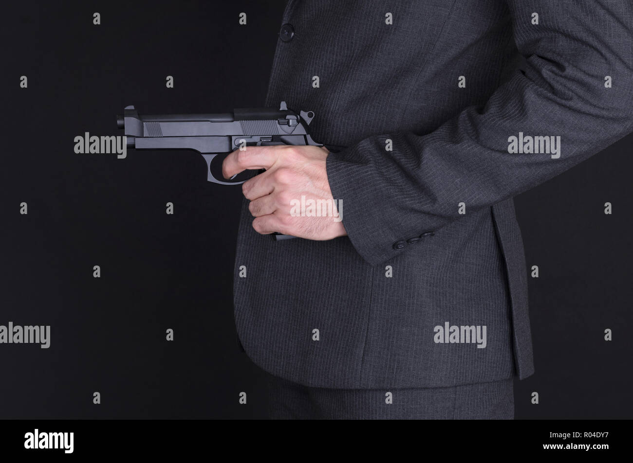 Man in suit with gun, isolated on black Stock Photo - Alamy