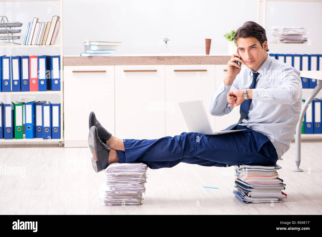 Extremely busy employee working in the office Stock Photo - Alamy