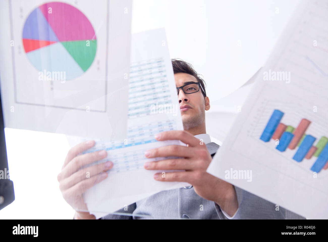 Businessman looking at financial charts and graphs Stock Photo - Alamy