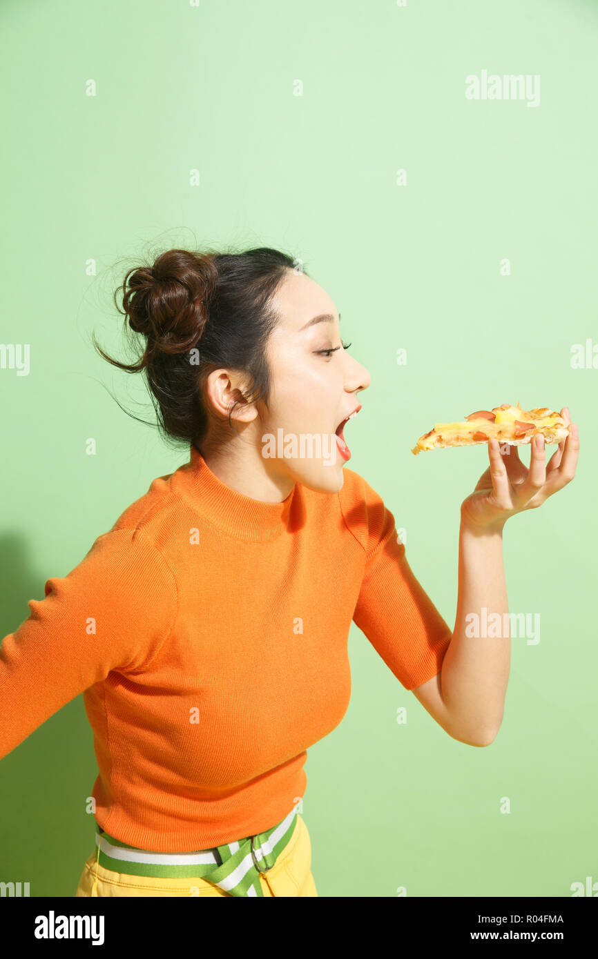 Side view woman eating pizza hi-res stock photography and images - Alamy