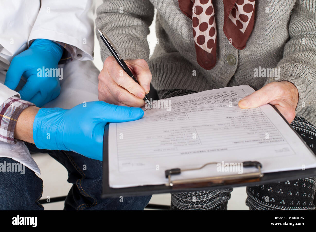 A senior woman's hand signing a document Stock Photo - Alamy