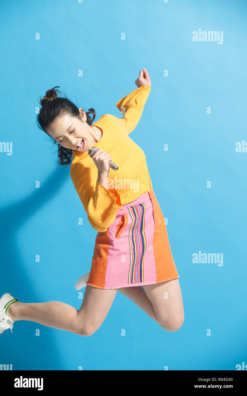 Young asian woman sings microphone hi-res stock photography and images ...